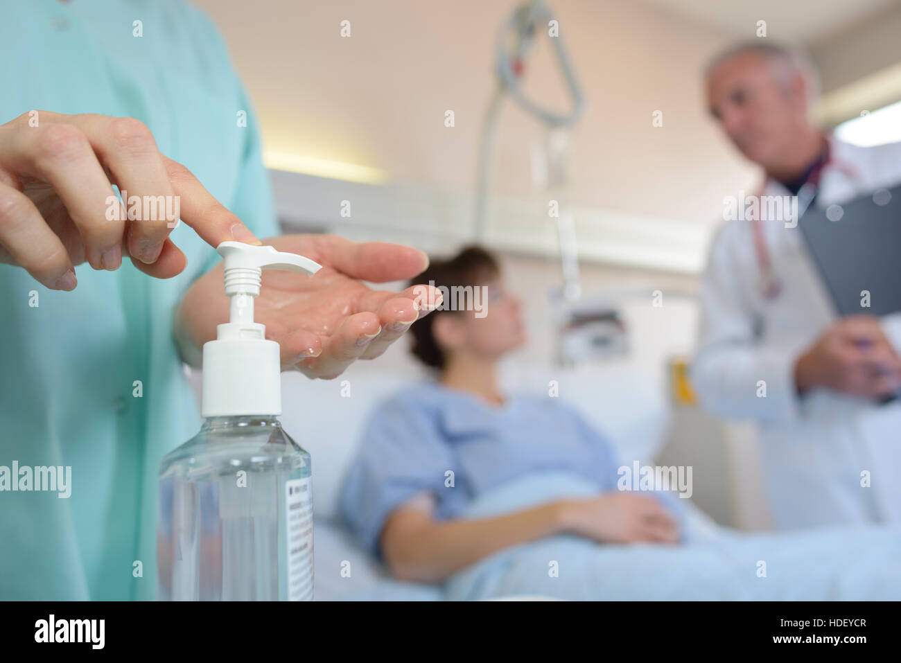 Medical worker applying hand sanitizer Stock Photo - Alamy