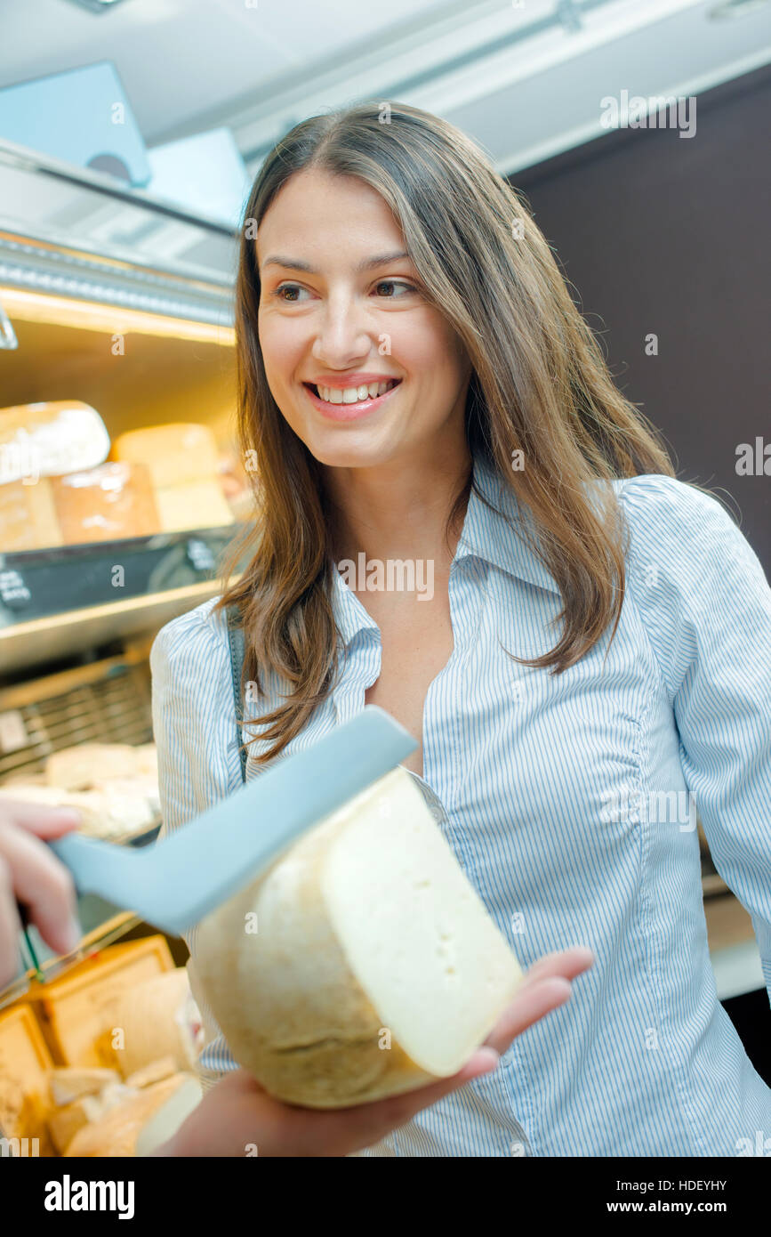 Lady being served with cheese Stock Photo - Alamy