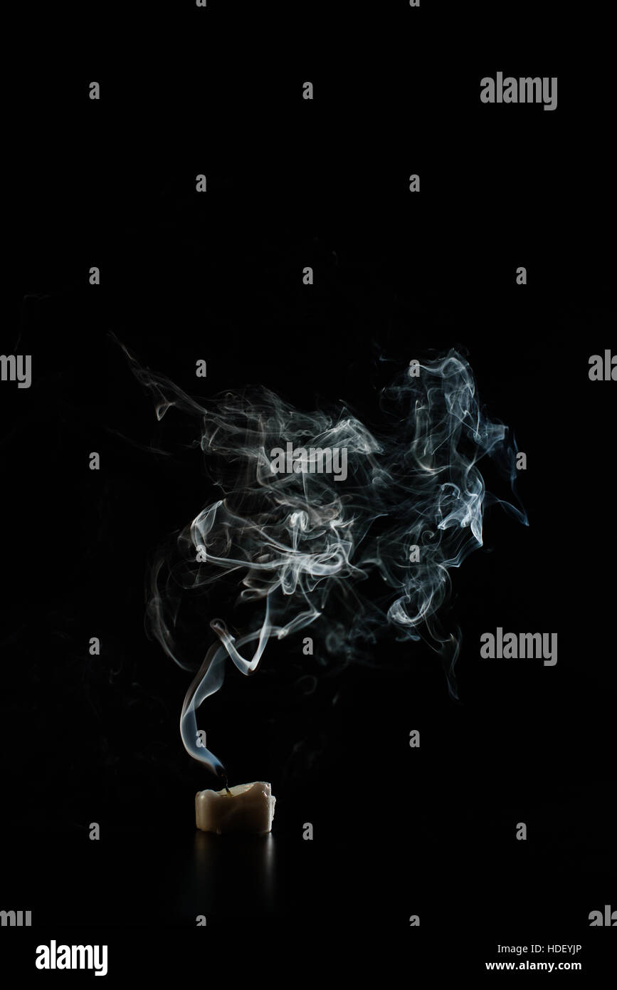 Slow blowing off candle in the dark Stock Photo - Alamy