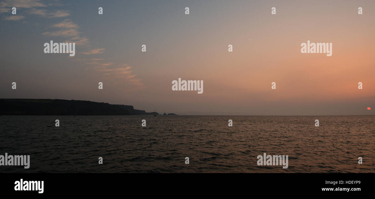 Calming sunrise over Monkstone Point looking across Carmarthen Bay ...
