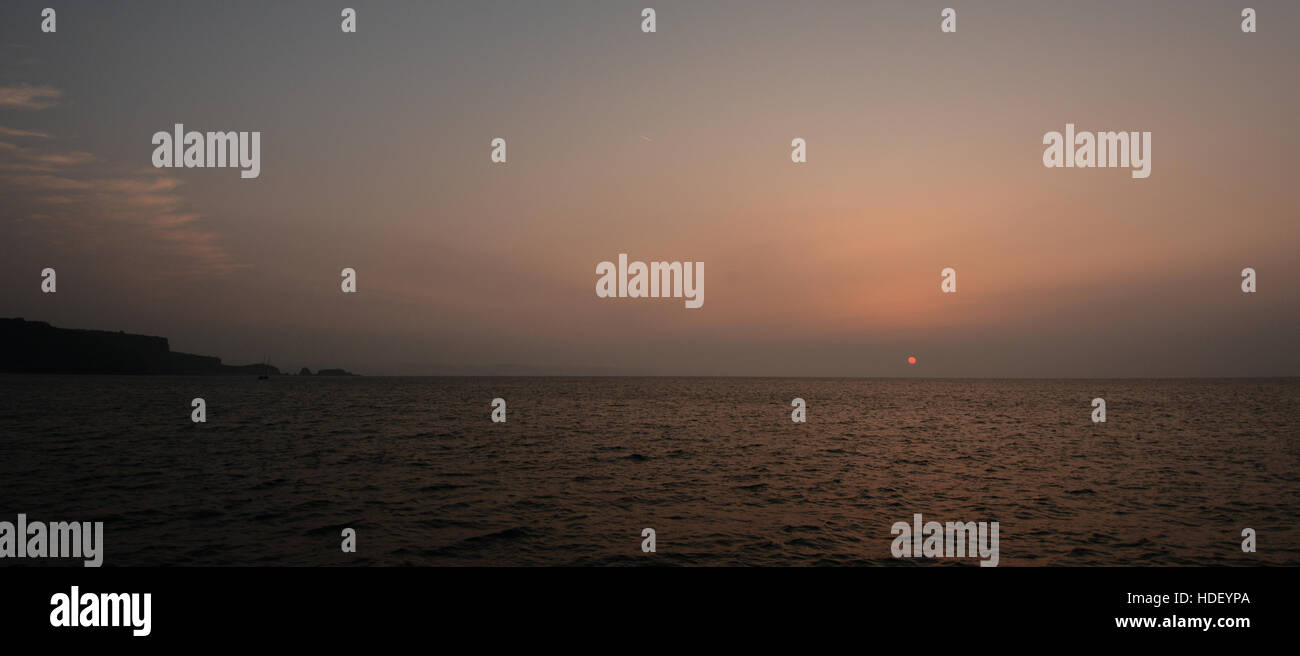 Calming sunrise over Monkstone Point looking across Carmarthen Bay ...