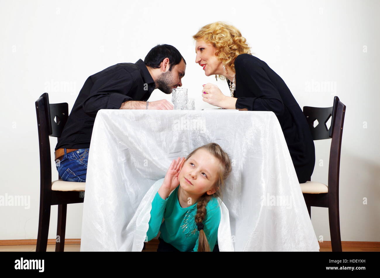 little girl listening to adults secrets Stock Photo - Alamy
