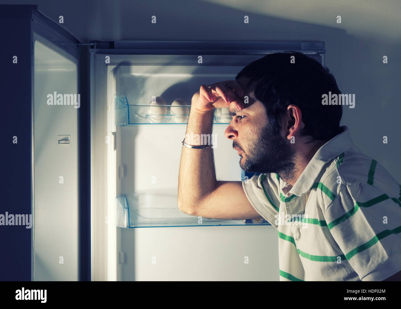 funny man looking into refrigerator Stock Photo - Alamy