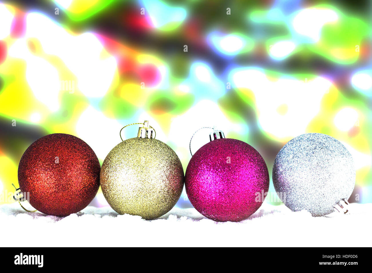 Balls on snow with colorful background Stock Photo - Alamy