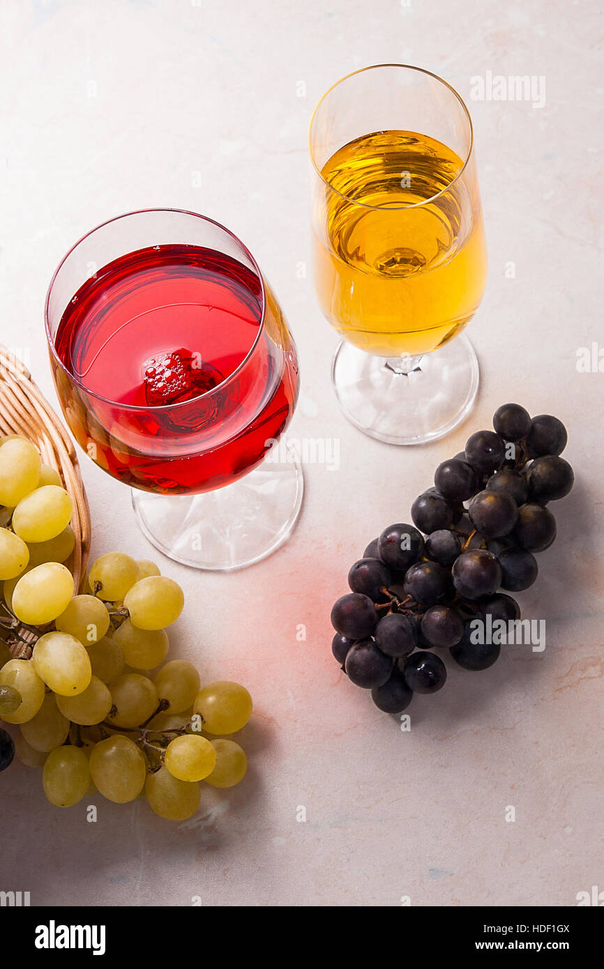 Two Glasses One With White Wine And One With Red Wine On Light Marble Background Bunches Of