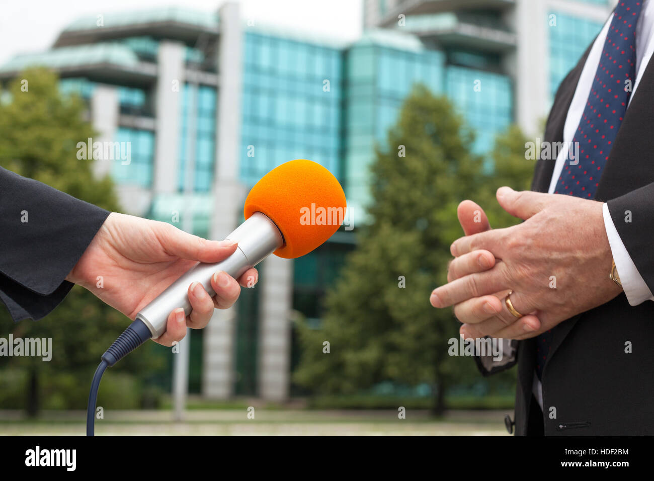 Female journalist conducting an interview with business person or ...