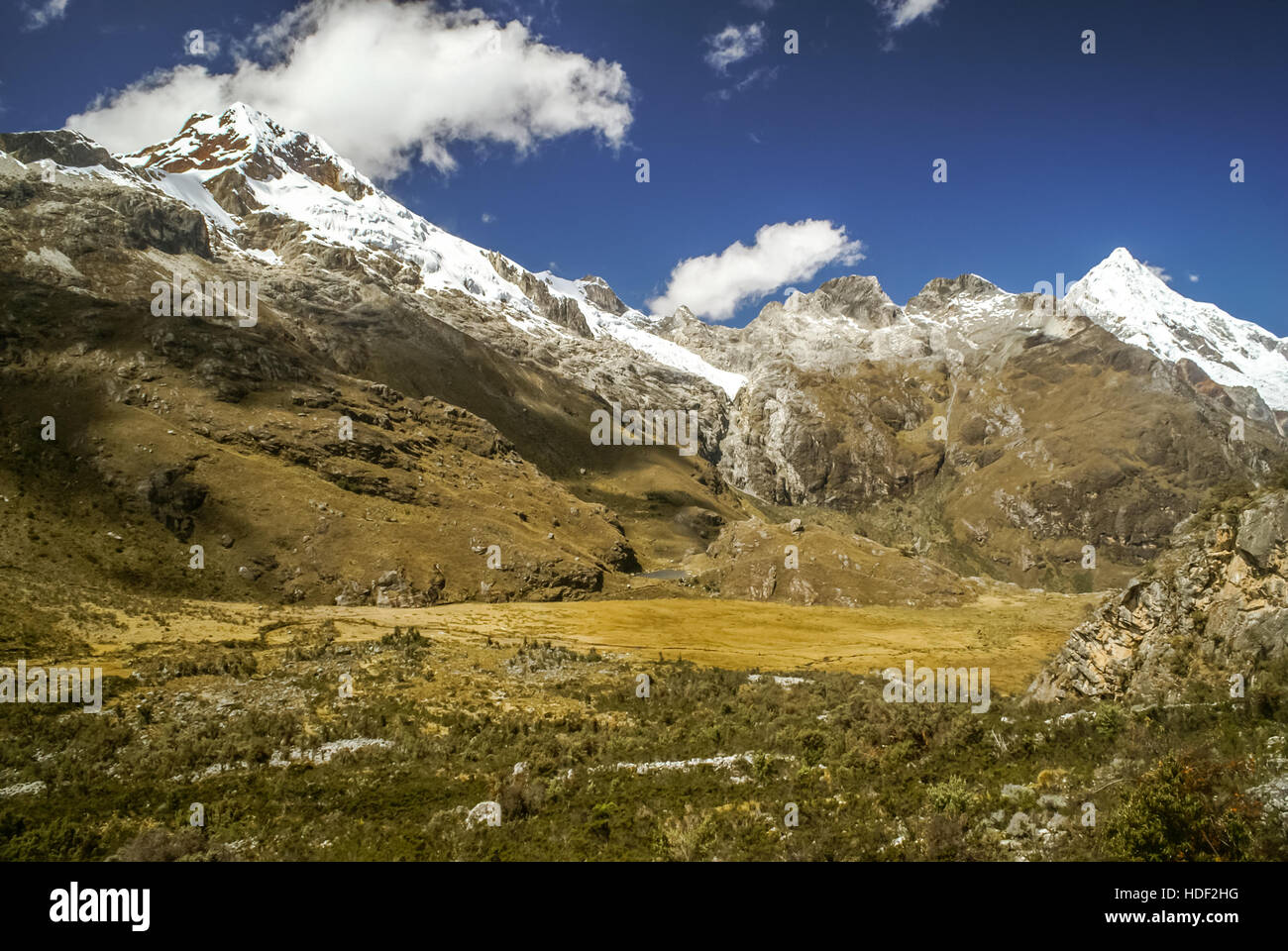 Photo of countryside with greenery and high mountain range with snowy ...