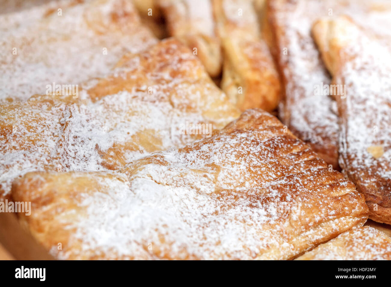 Row of freshly sweet buns with sugar powder, selective focus Stock ...