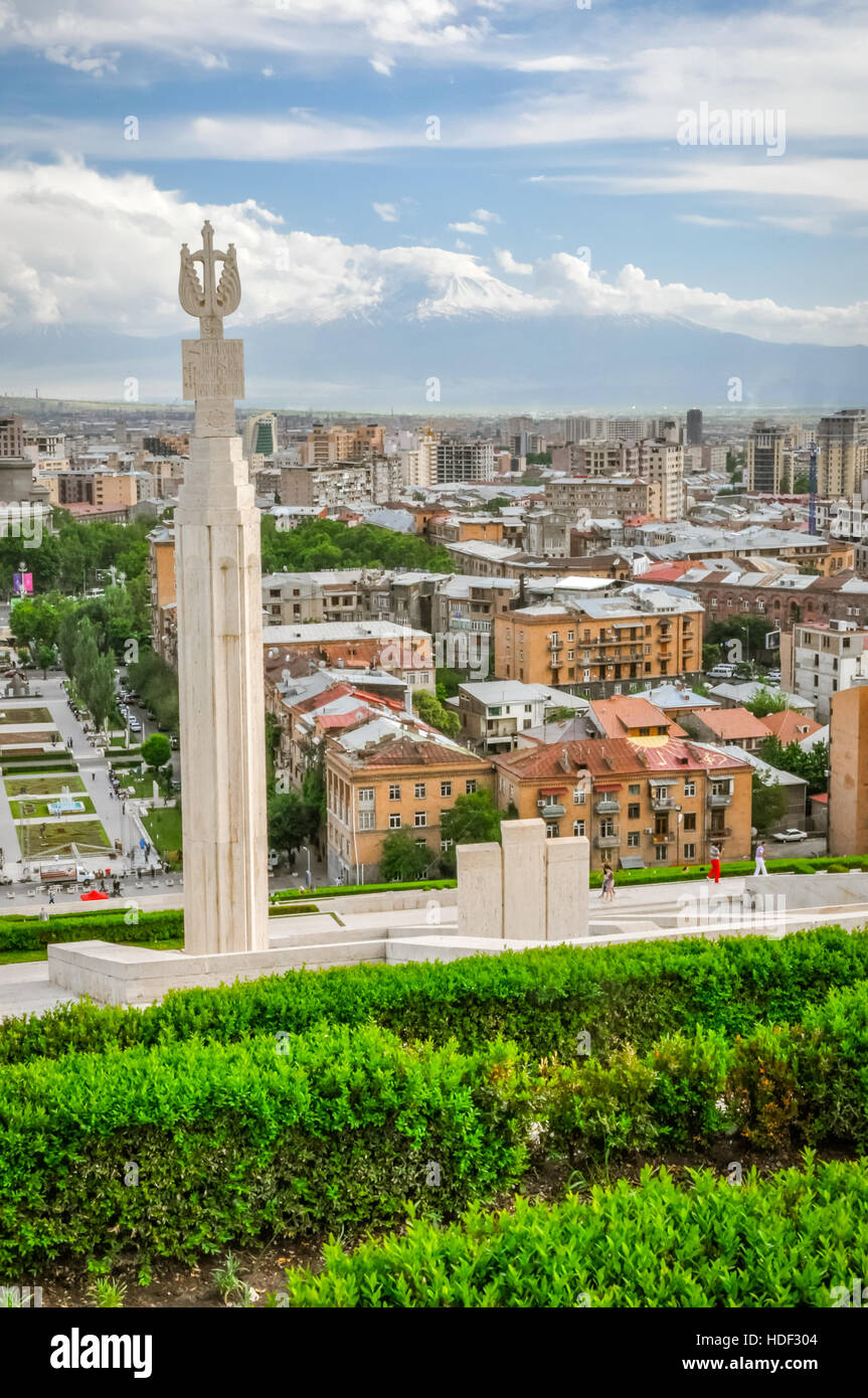 Photo of large monument surrounded by greenery and buildings of capital ...
