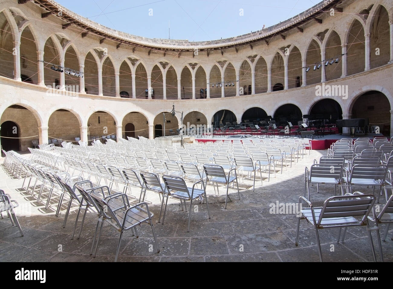 Bellver castle interior scene with grand piano and seats on a sunny ...