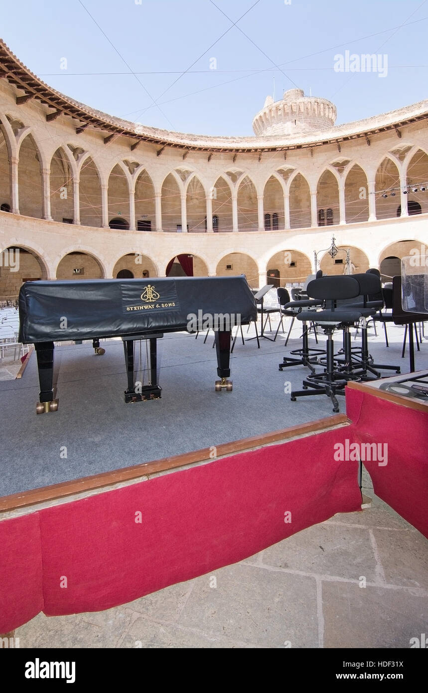 Bellver castle interior scene with grand piano and seats on a sunny ...