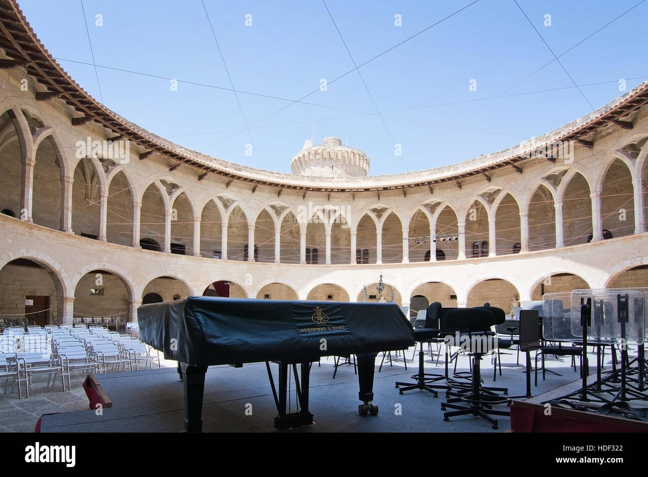 Bellver castle interior scene with grand piano and seats on a sunny ...