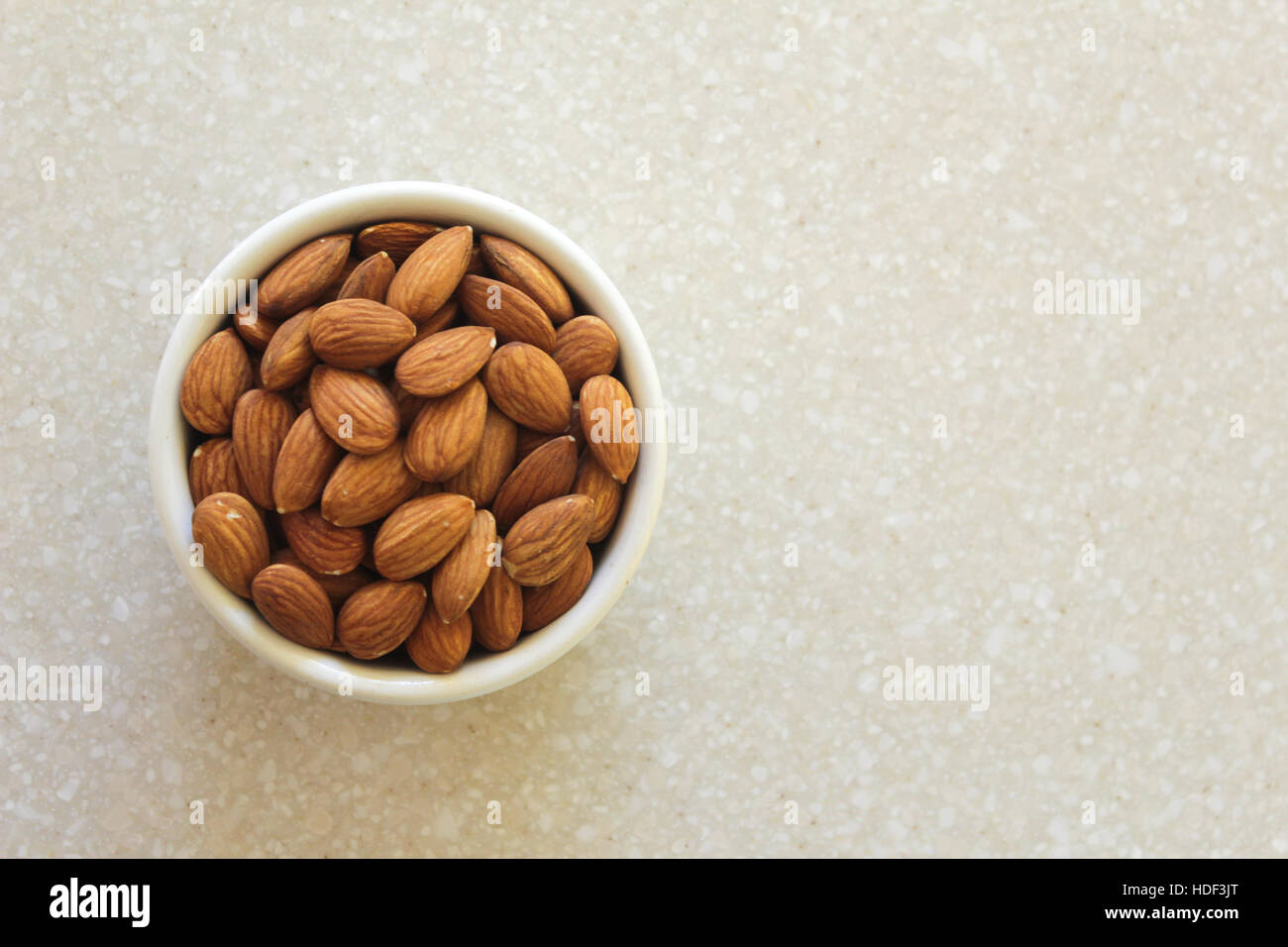 Delicious almonds in a container on a kitchen countertop, ready to ...