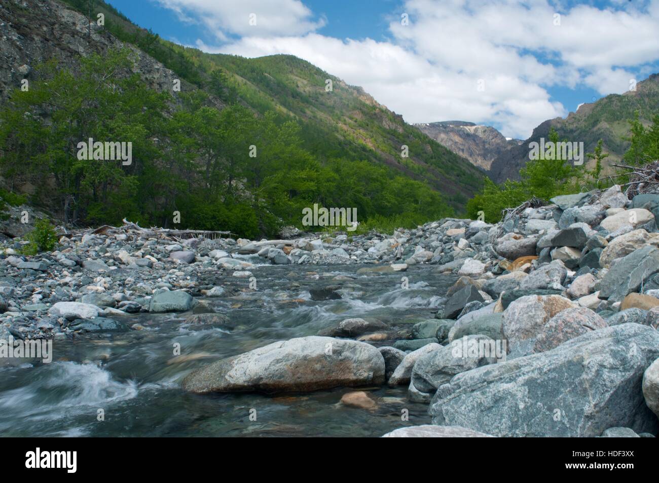 River amongst stone in valley mountains Stock Photo - Alamy