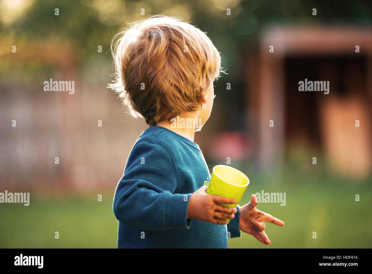 Boy looking back. blur background Stock Photo - Alamy