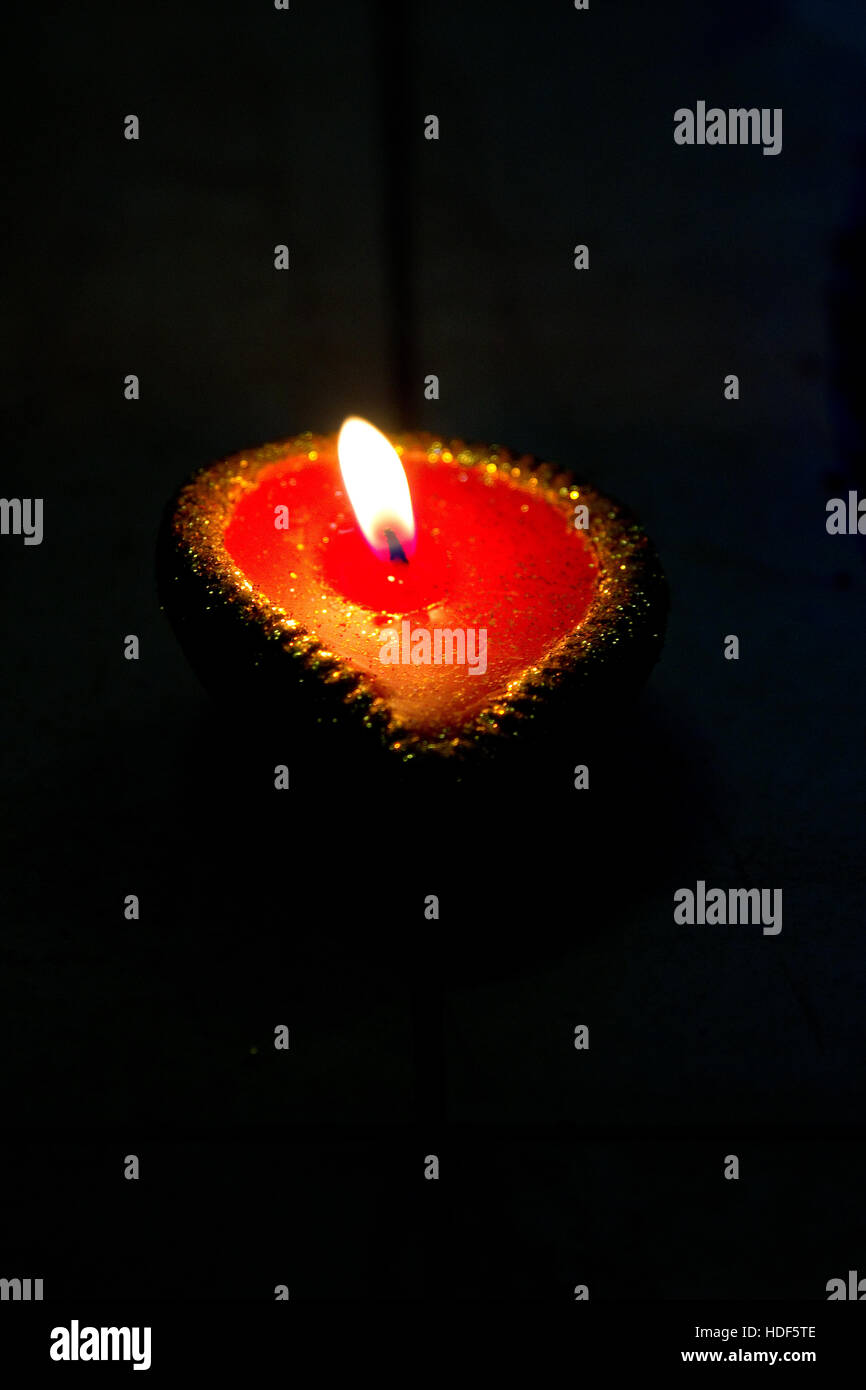 An oil lamp (diya) on a dark background during Diwali celebrations in ...