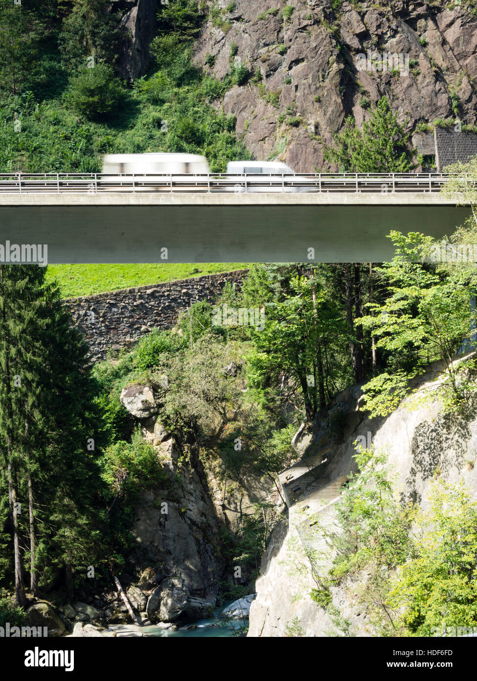 A blurred caravan is driving on a highway bridge of Switzerland's ...