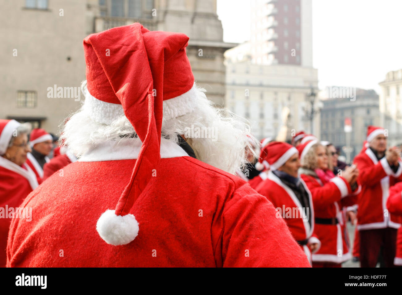 People dancing in a square with Santa Claus costumes in Italy Stock ...
