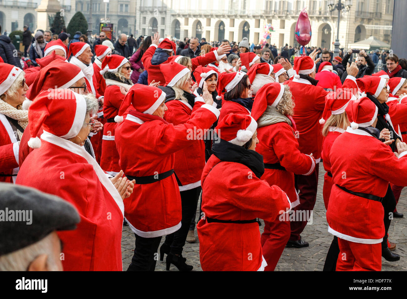 People dancing in a square with Santa Claus costumes in Italy Stock ...