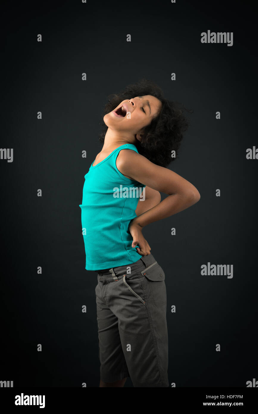 Handsome boy doing different expressions in different sets of clothes: backache Stock Photo - Alamy