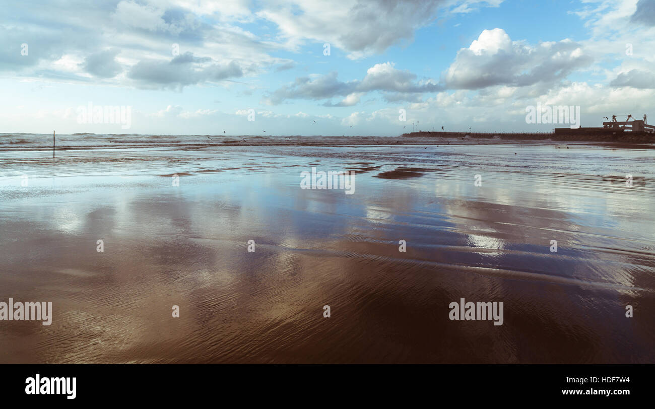 Sea waves with a reflection on the shore Stock Photo - Alamy