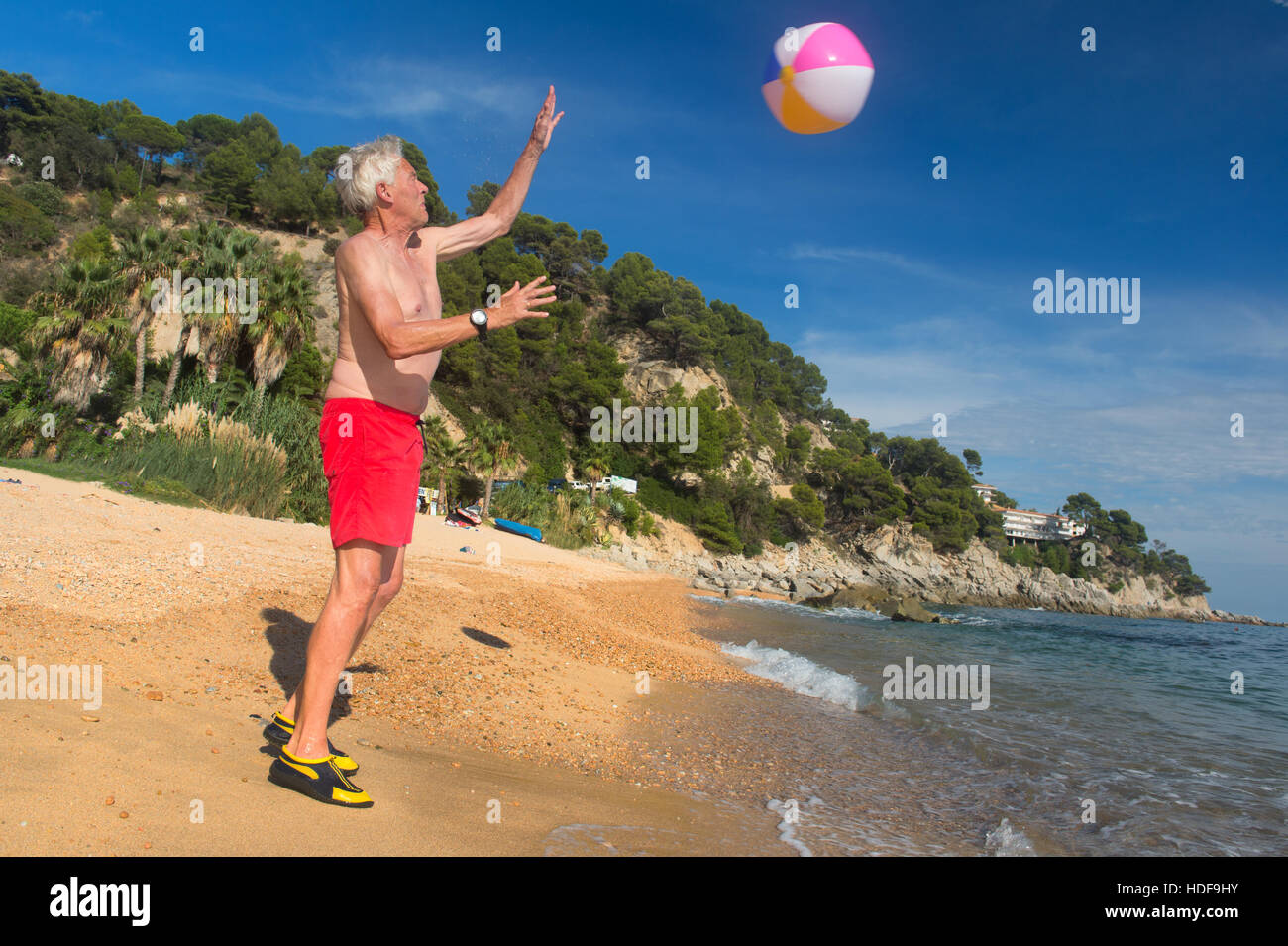 Man playing with inflatable ball at the beach Stock Photo - Alamy
