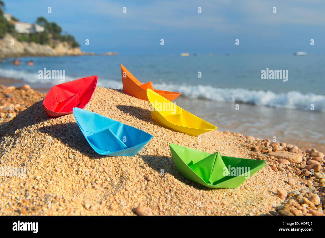 many colorful paper boats at the beach to play with Stock Photo - Alamy