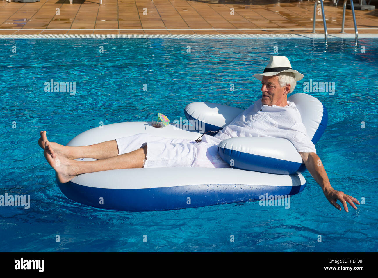 wealthy man relaxing in own swimming pool Stock Photo - Alamy