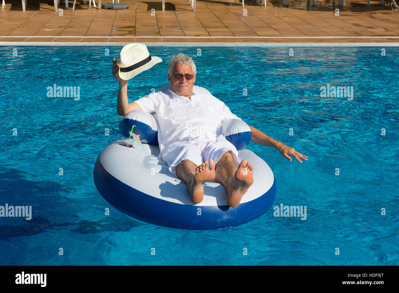 wealthy man relaxing in own swimming pool Stock Photo - Alamy