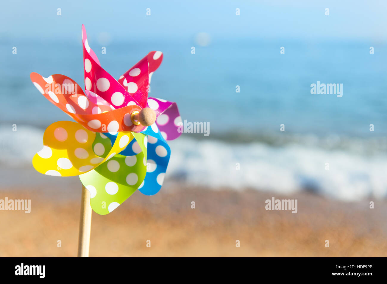 Colorful toy wind turbine at the beach Stock Photo - Alamy