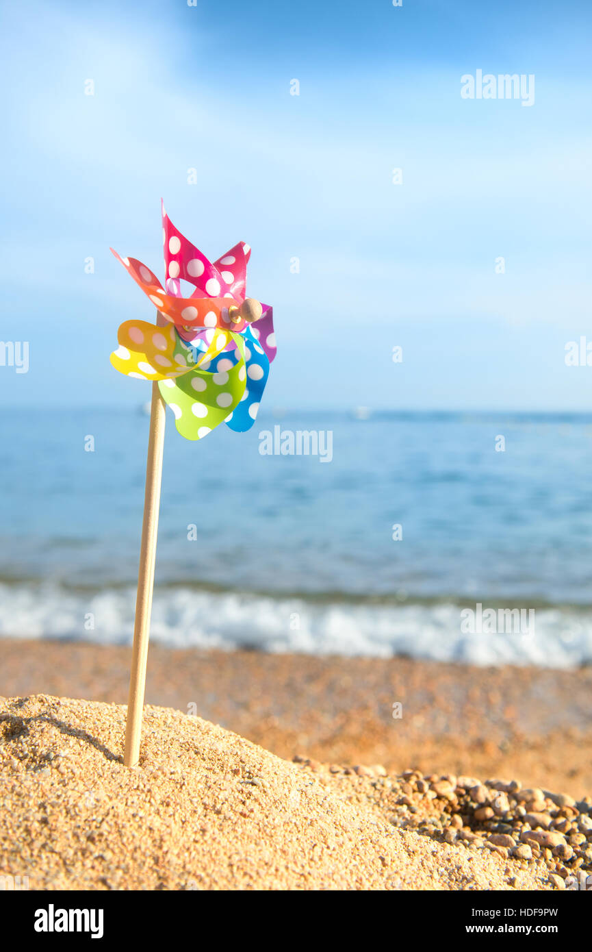 Colorful toy wind turbine at the beach Stock Photo - Alamy