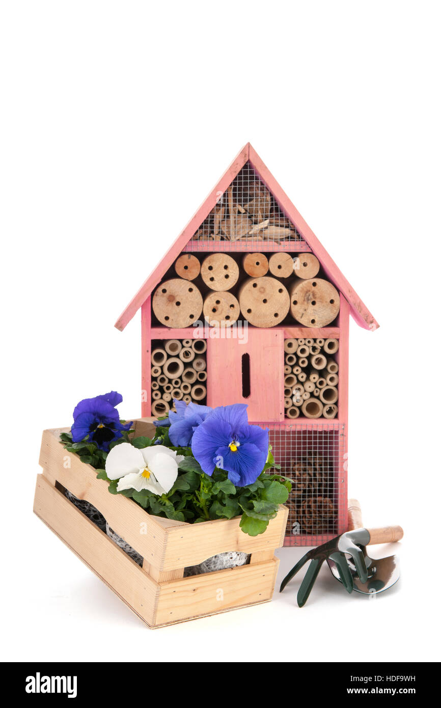 Pink hotel for insects and garden equipment Stock Photo - Alamy
