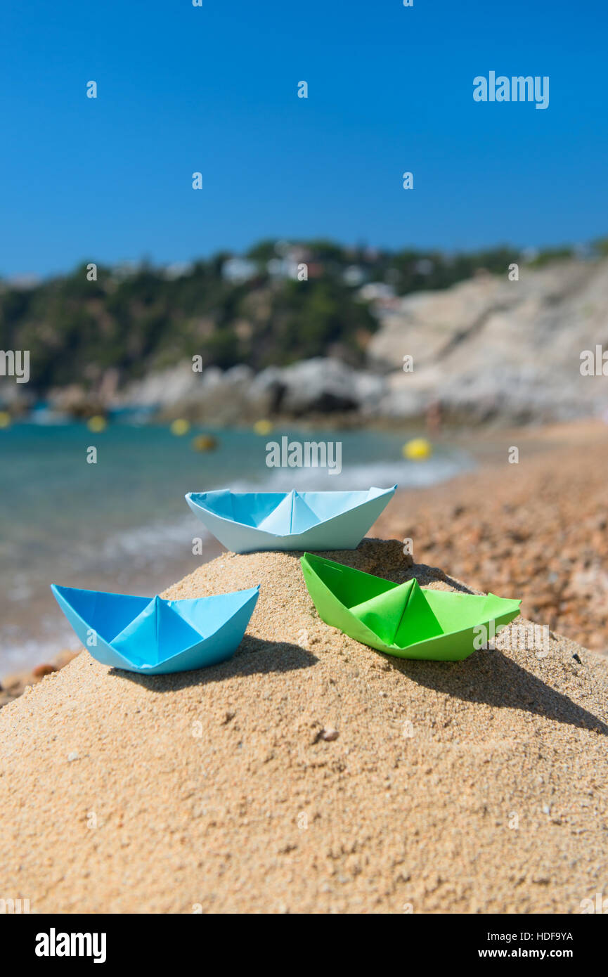 Paper boats in the sand at the beach Stock Photo - Alamy
