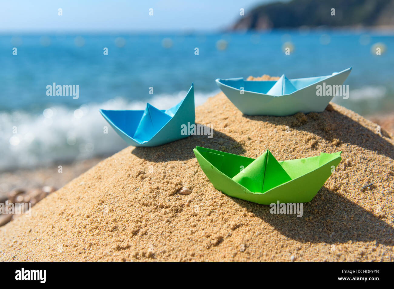 Paper boats in the sand at the beach Stock Photo - Alamy