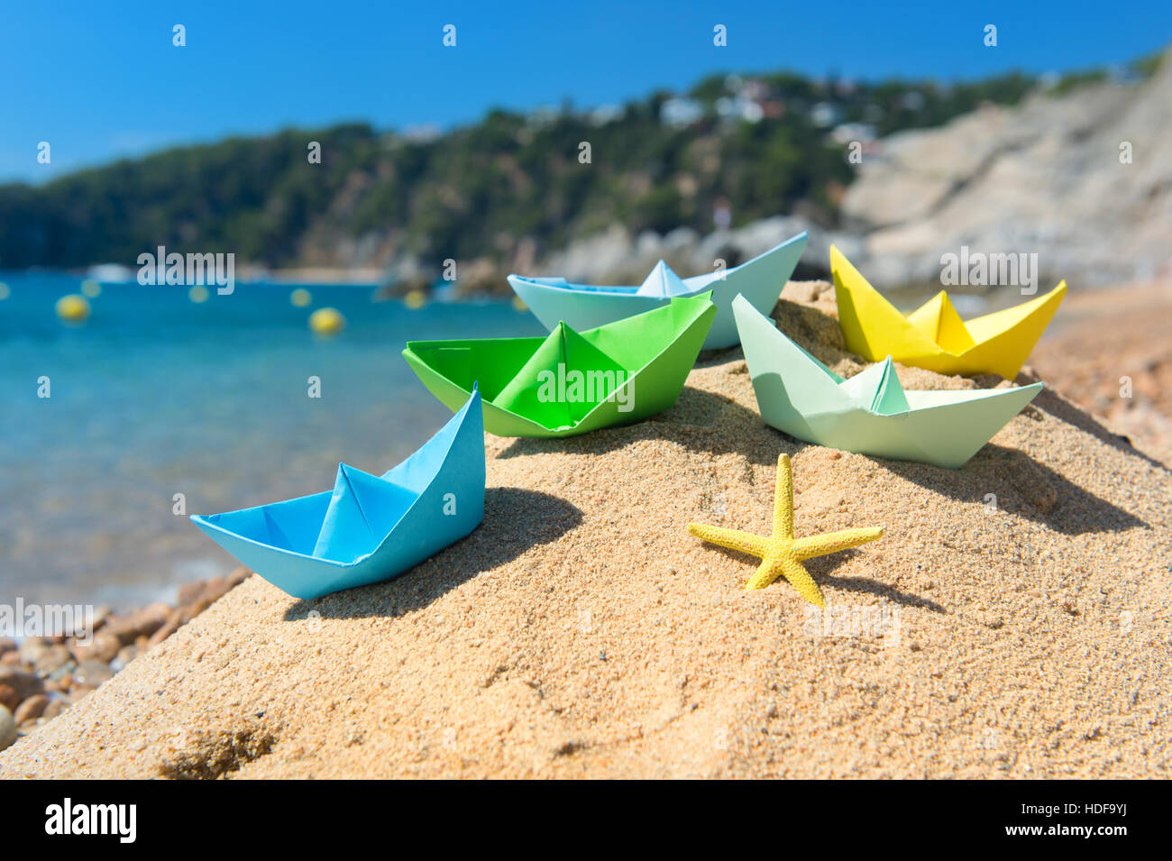 Paper boats in the sand at the beach Stock Photo - Alamy