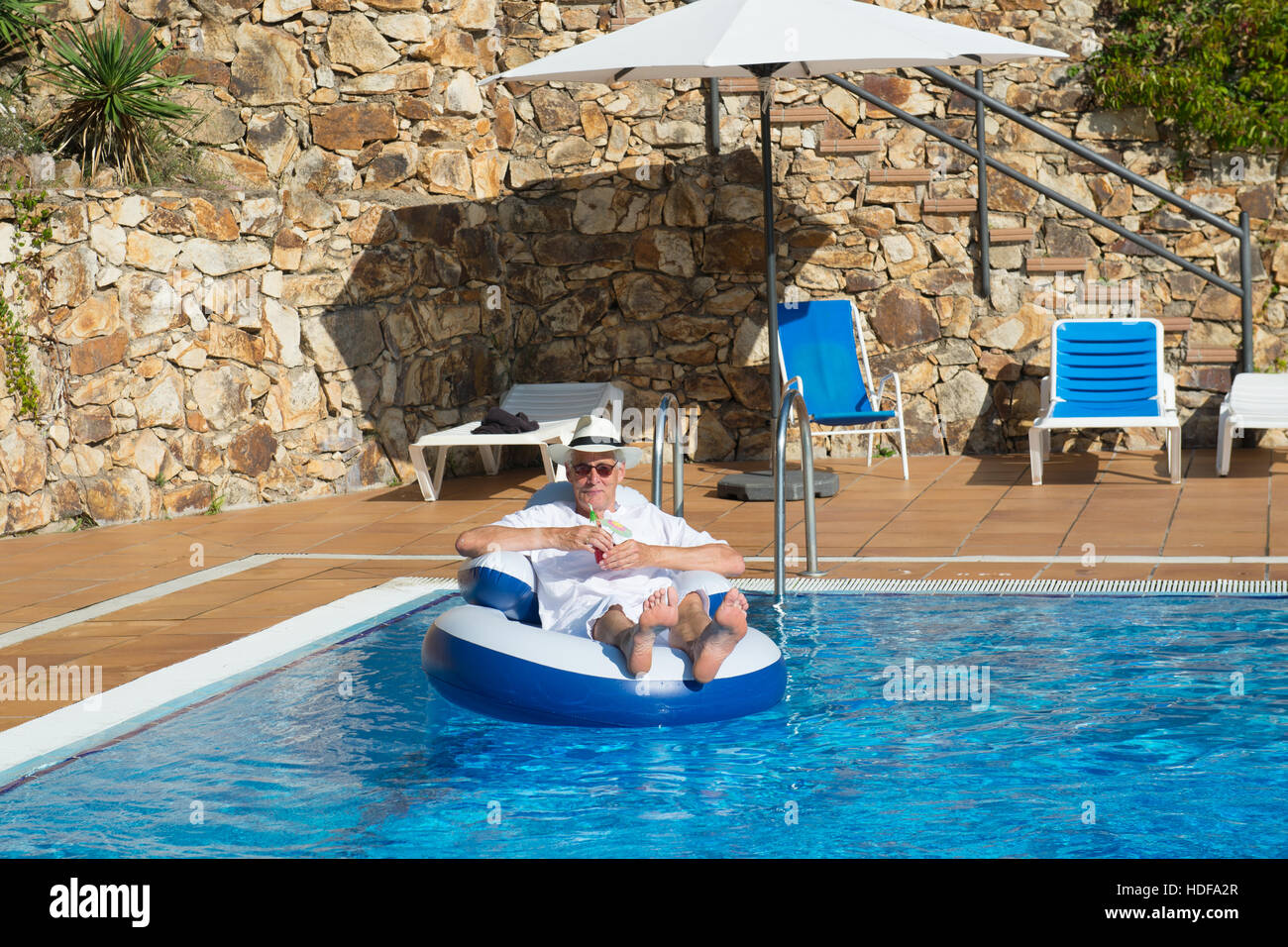 wealthy man relaxing in own swimming pool Stock Photo - Alamy