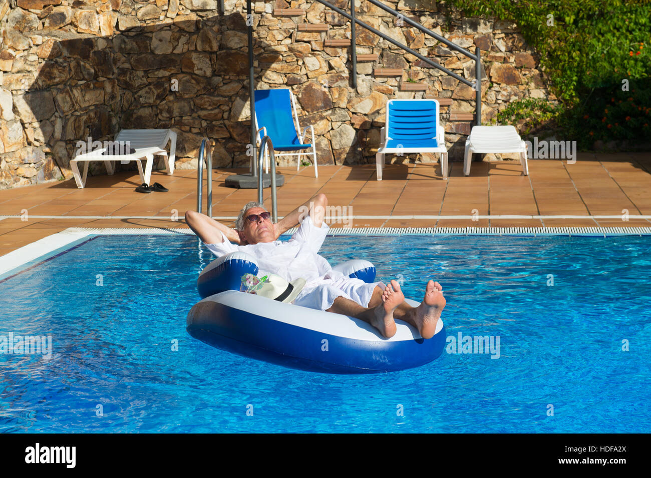 wealthy man relaxing in own swimming pool Stock Photo - Alamy