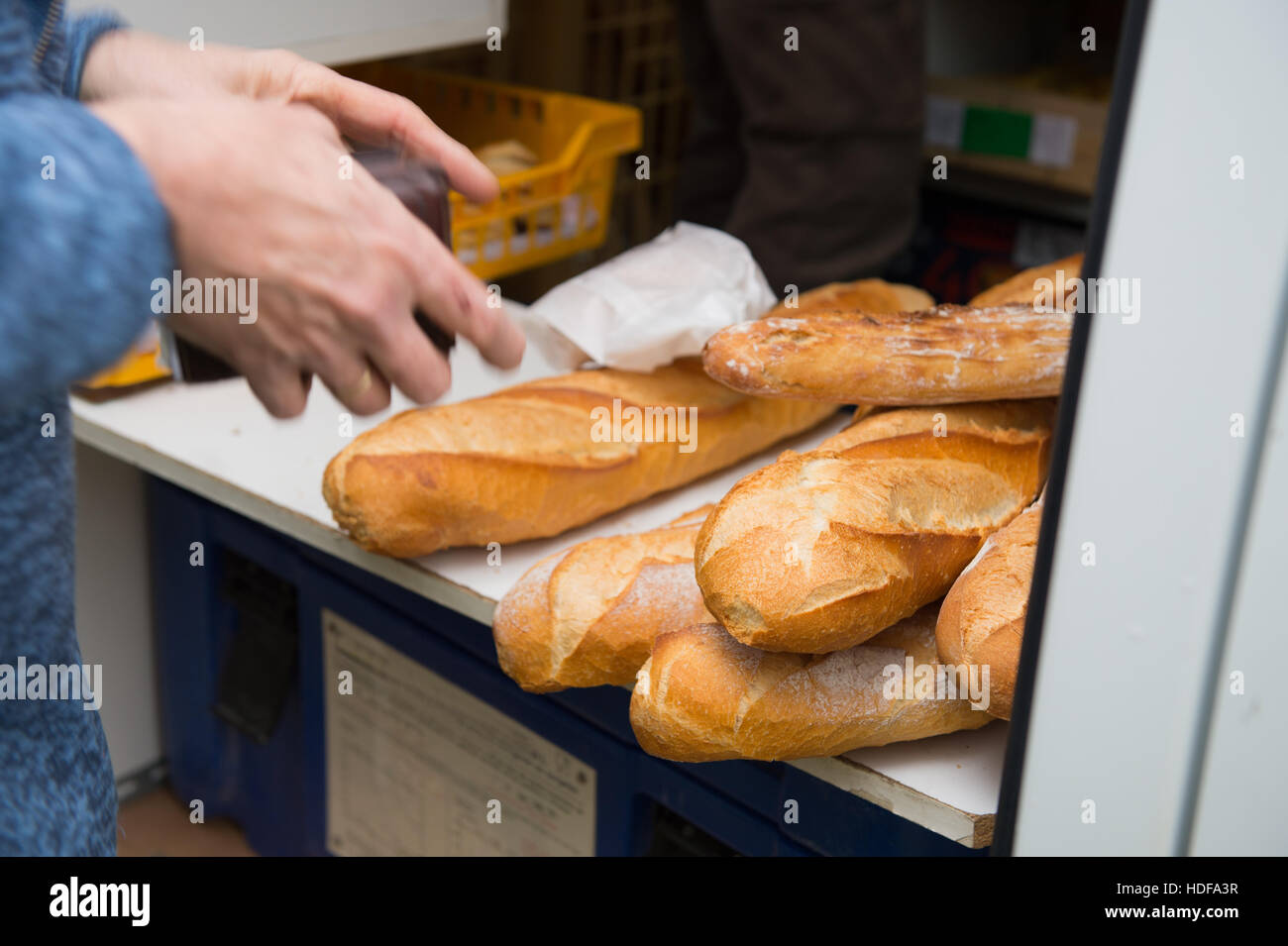 Buying fresh French bread in bakery Stock Photo - Alamy