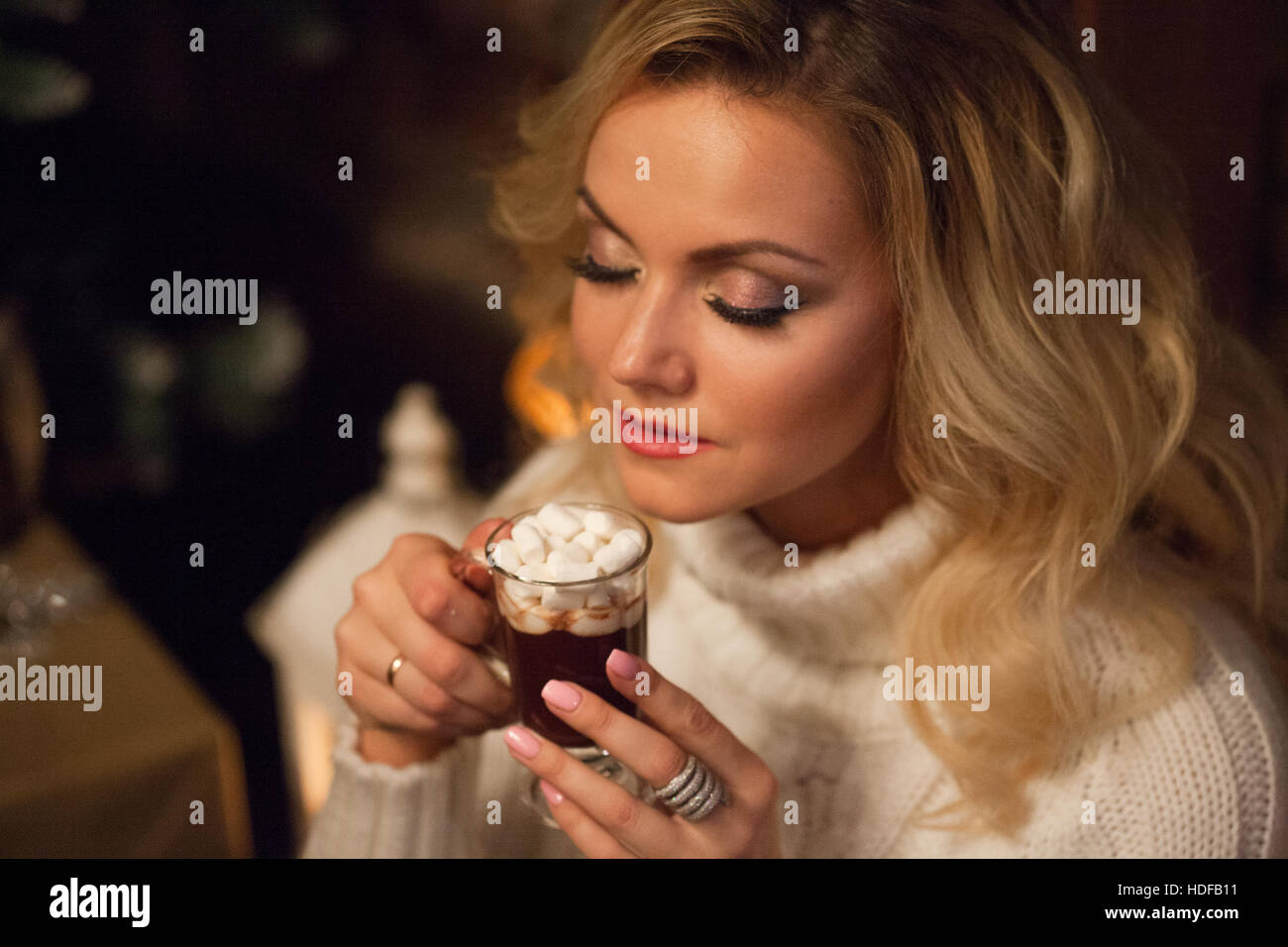 Woman drinking hot chocolate fire hi-res stock photography and images ...