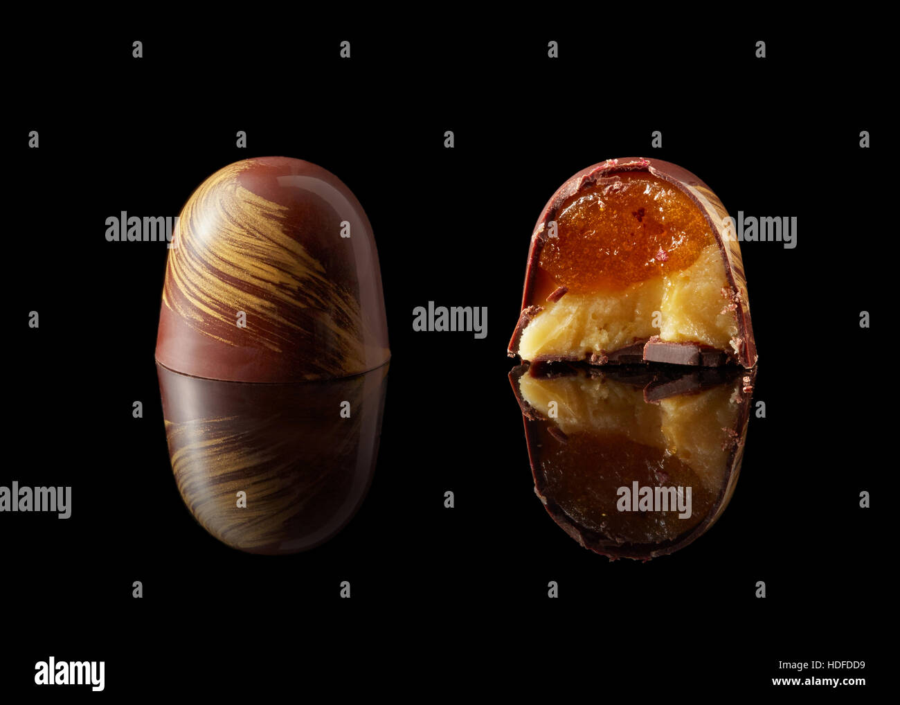 tasty yellow chocolate candy on a black background Stock Photo - Alamy