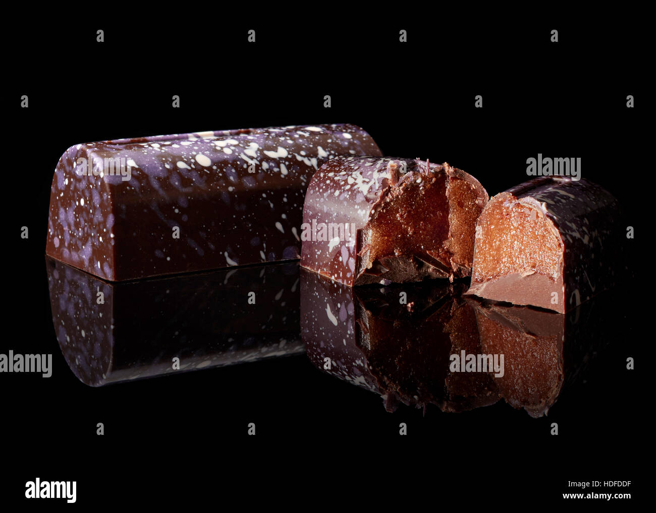 tasty yellow chocolate candy on a black background Stock Photo - Alamy