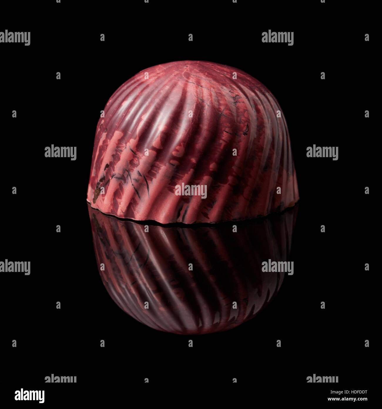 delicious red chocolate candy on a black background Stock Photo - Alamy
