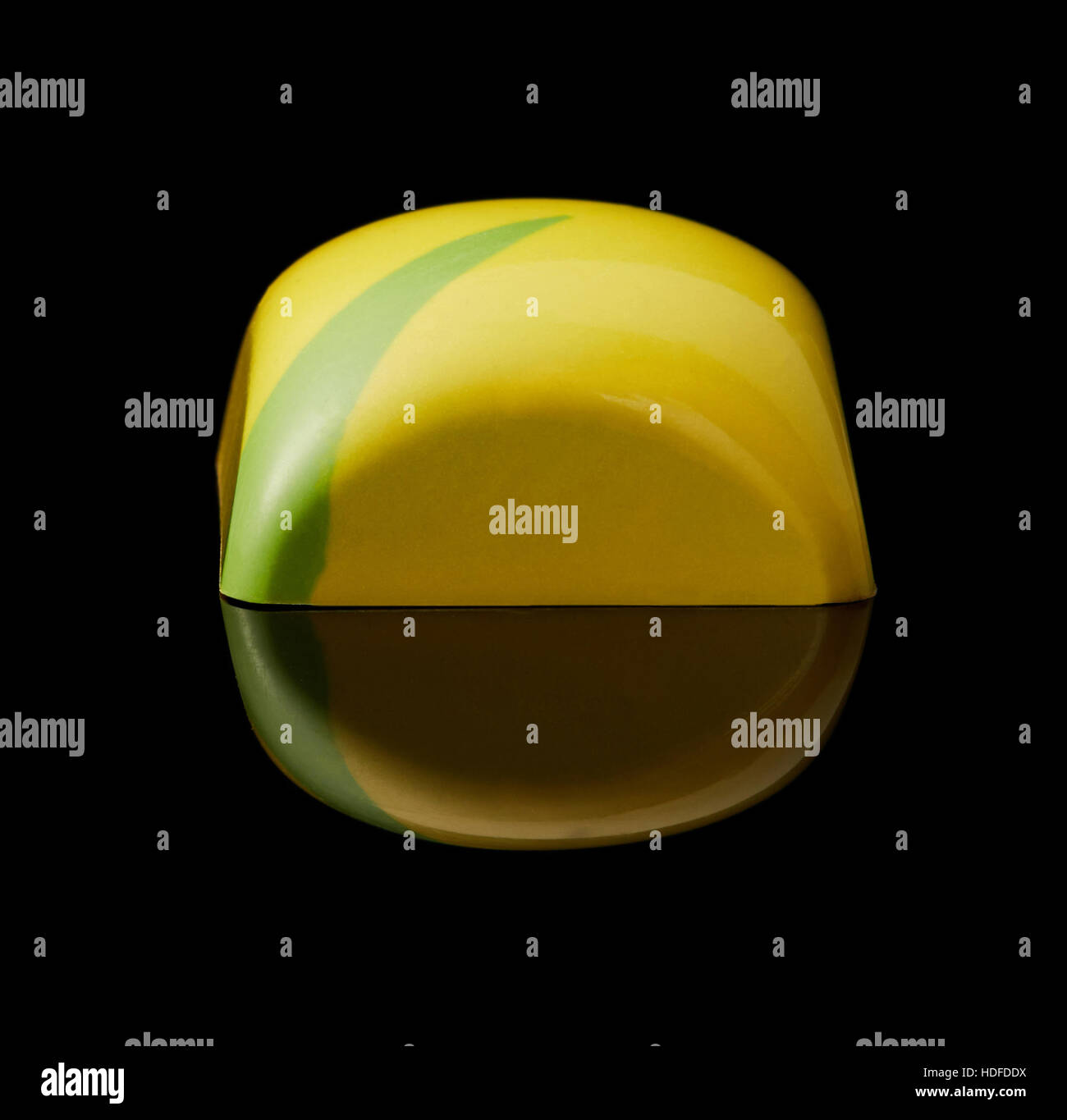 tasty yellow chocolate candy on a black background Stock Photo - Alamy