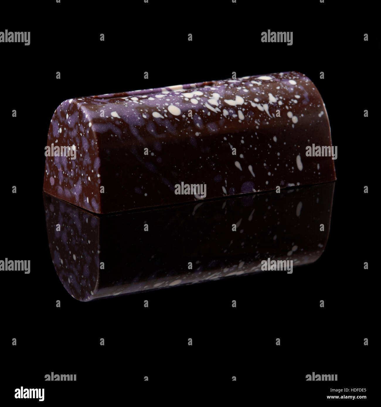 Sideways chocolate candy on a black background Stock Photo - Alamy