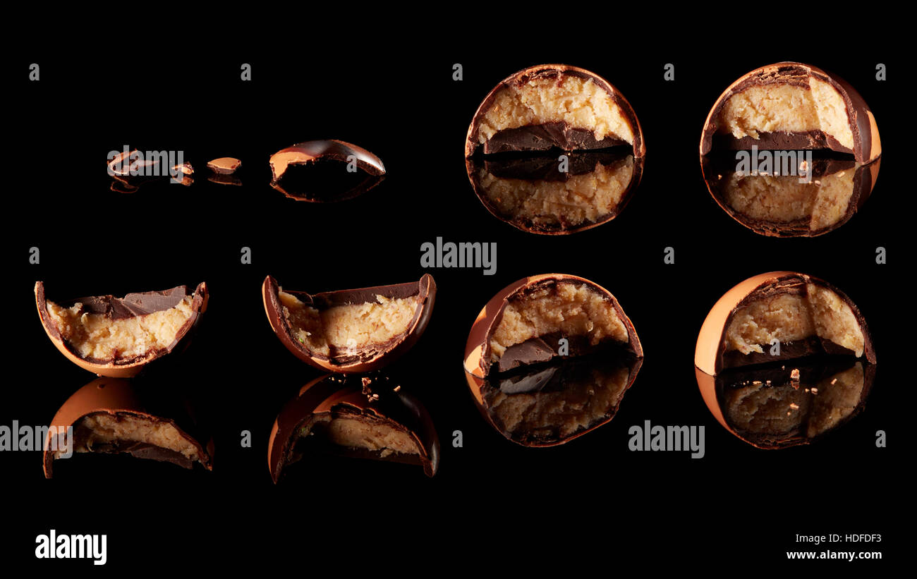 Soft chocolate covered candy filled with soft stuffing on a black ...