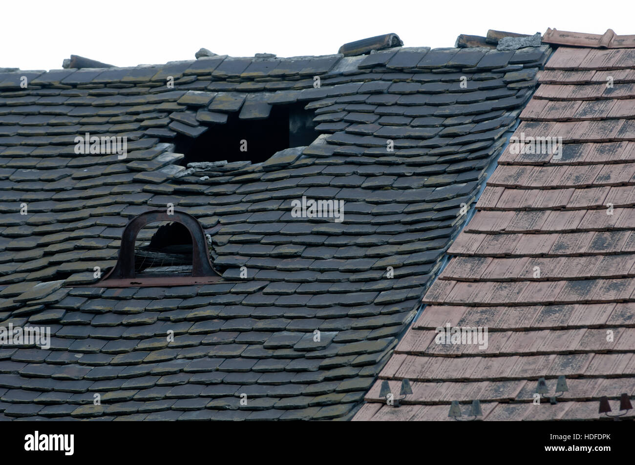 Damaged old tiled roof broken leaked Stock Photo - Alamy