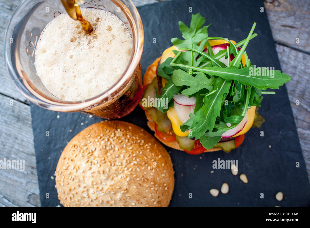 Homemade beef burger and soda on a black slate background, top view ...