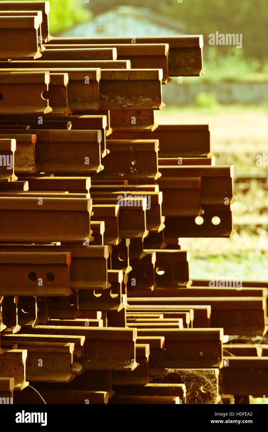 Stack of rusty railway tracks beside the track Stock Photo - Alamy