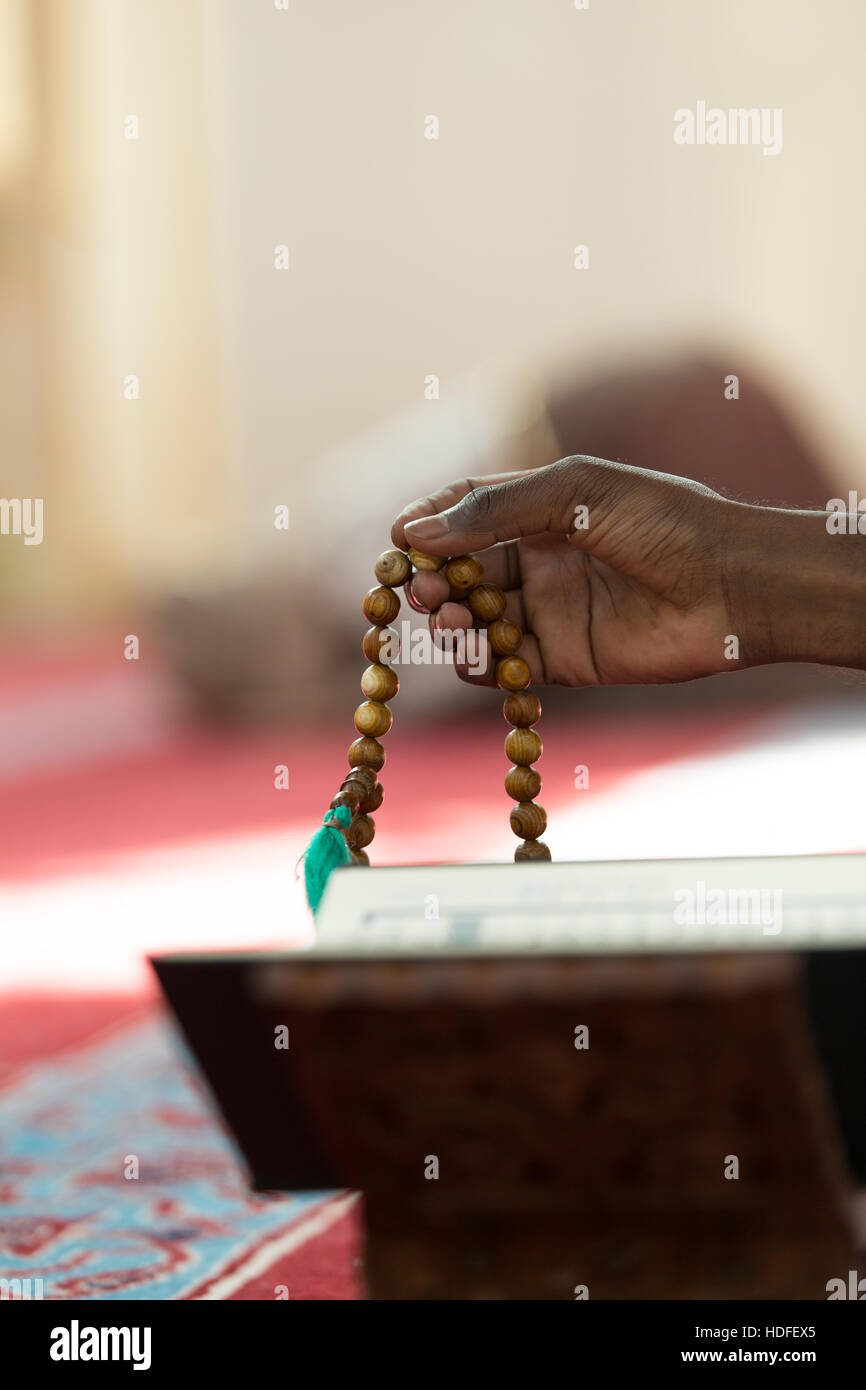 Hand of muslim black man people praying with mosque interior background ...