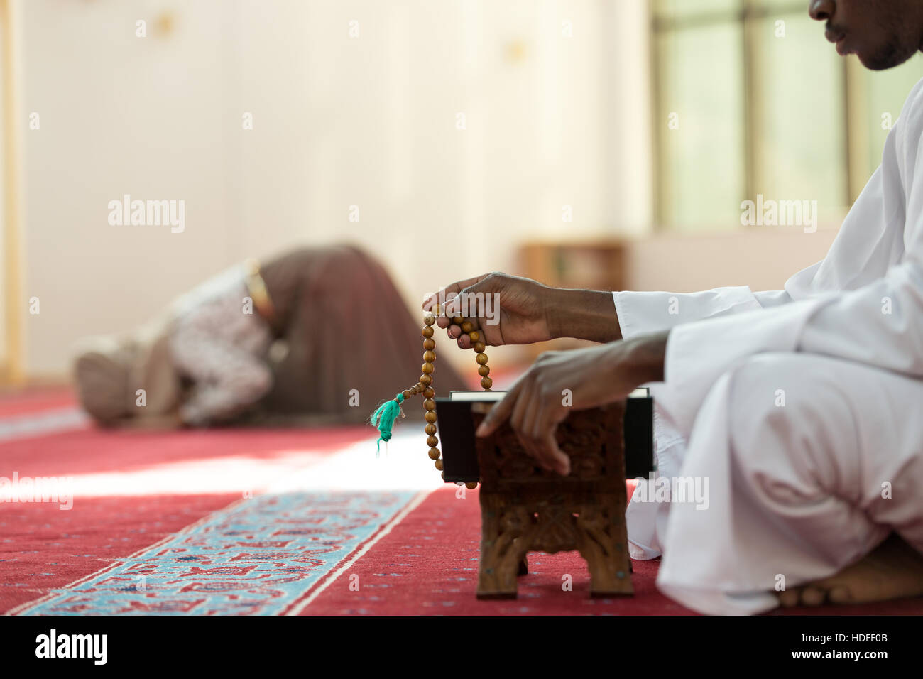 Hand of muslim black man people praying with mosque interior background ...